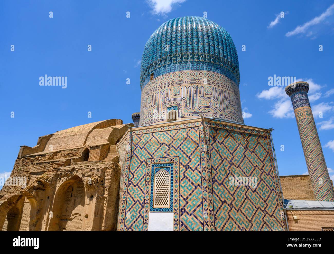 The mosque with a turquoise carved dome and minaret with patterns and ...