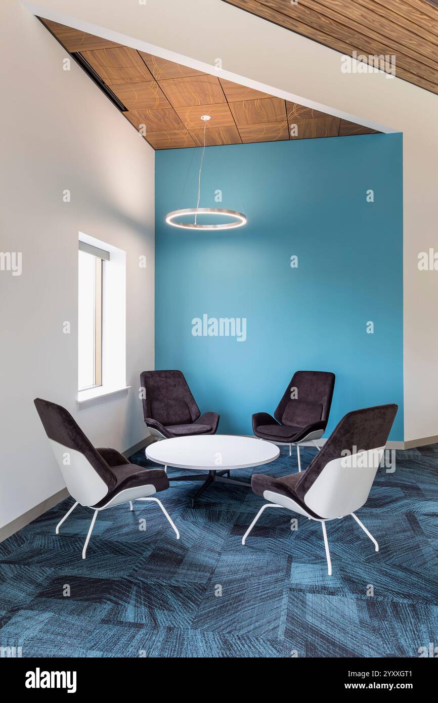 Modern chairs and table in corner of office reception area Stock Photo ...