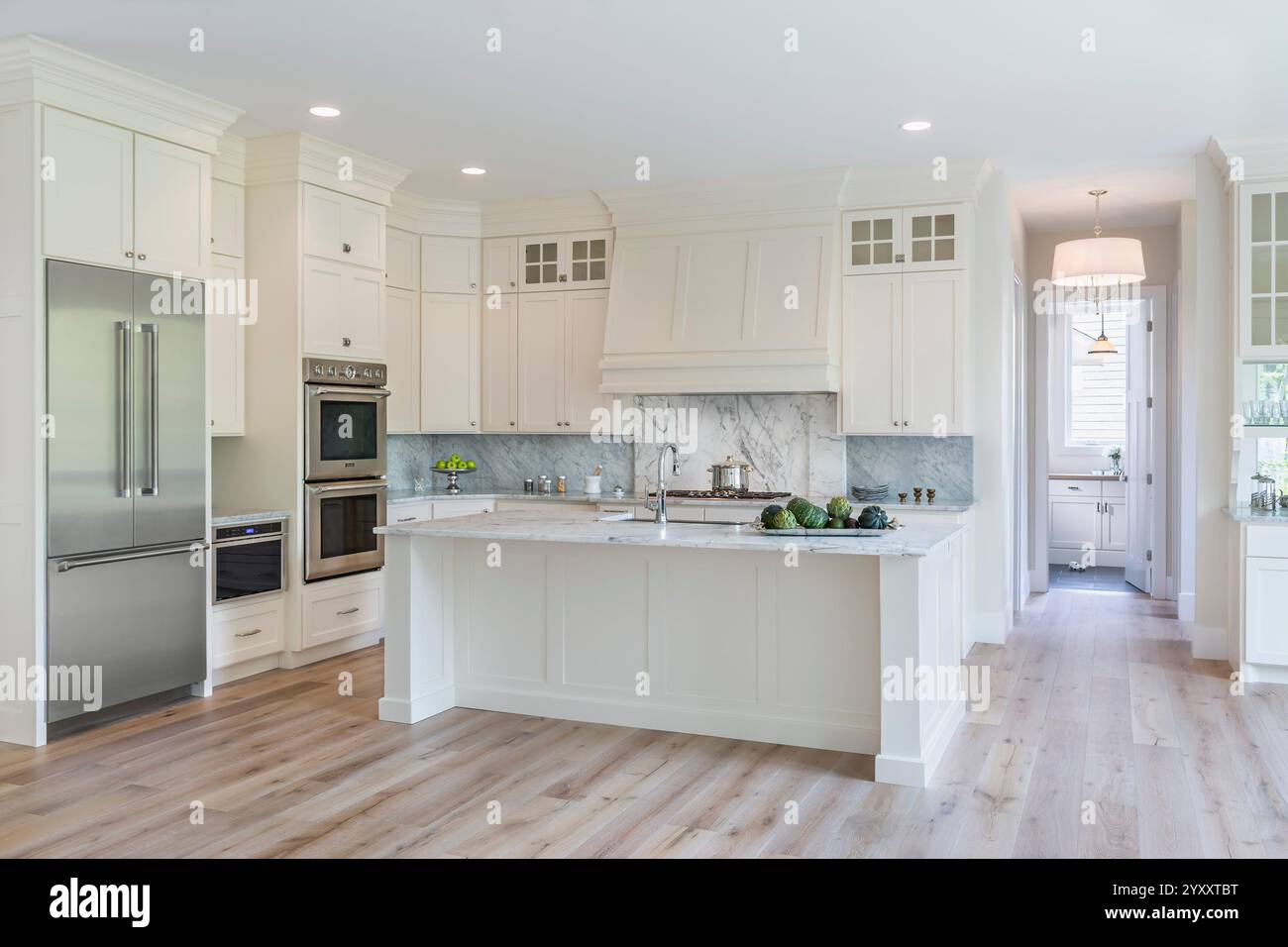 Kitchen with cream colored cabinets and marble backsplash Stock Photo ...