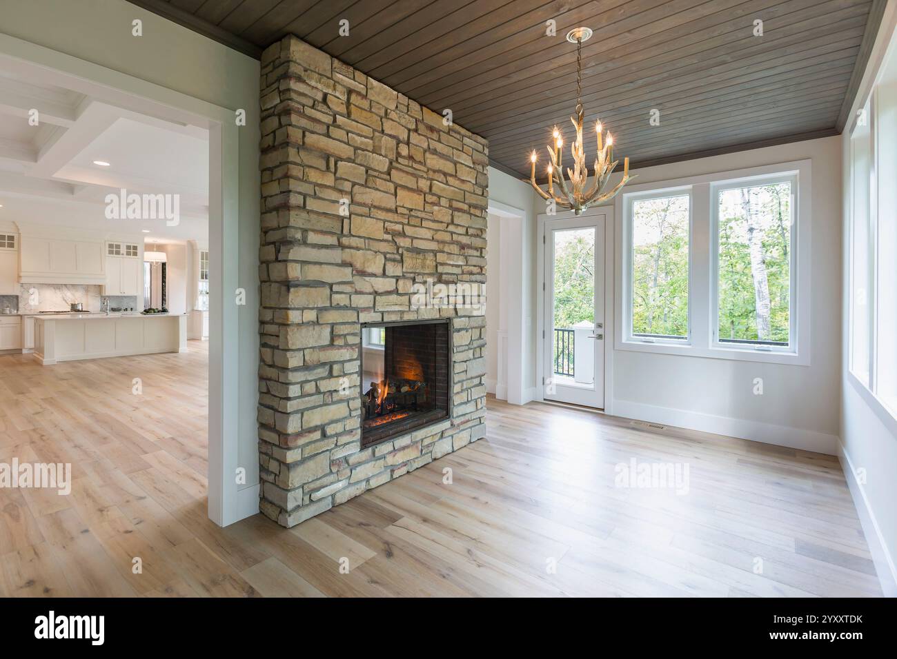 Four season sun porch with two sided stone fireplace Stock Photo - Alamy