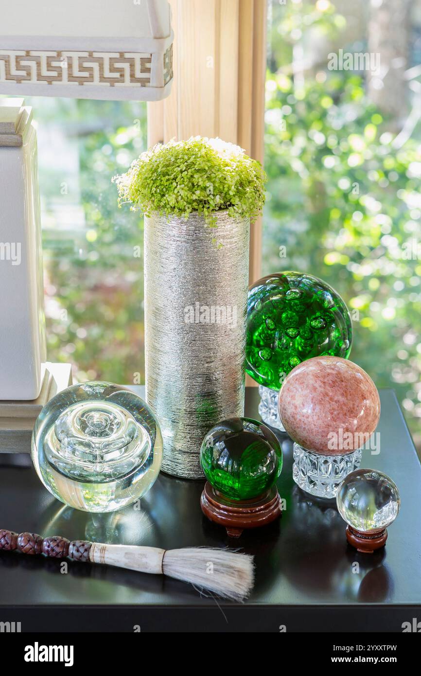 Collection of paperweights and other objects on table in front of ...