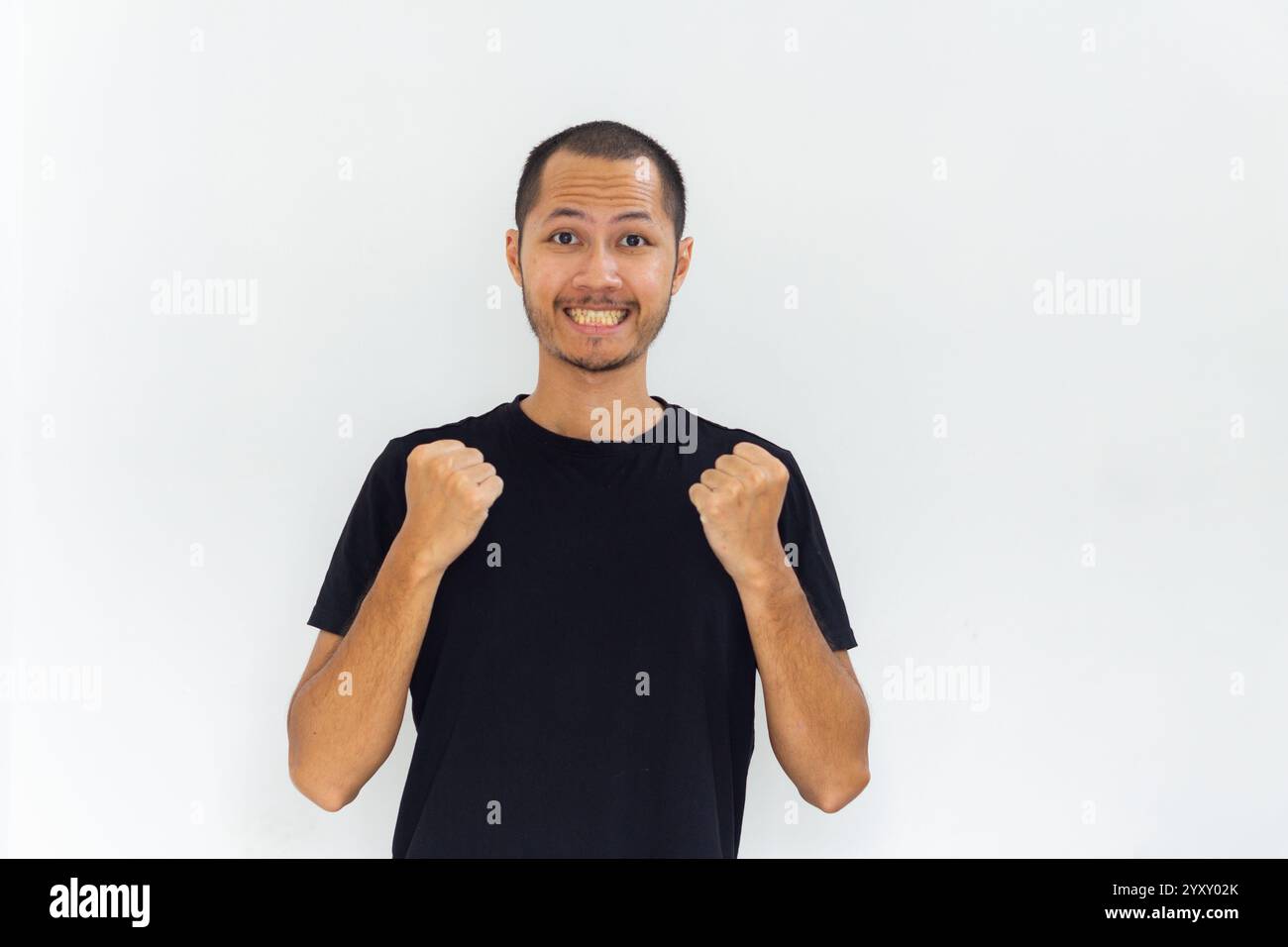 Young men is posing winning gesture with palm fist hand with black ...