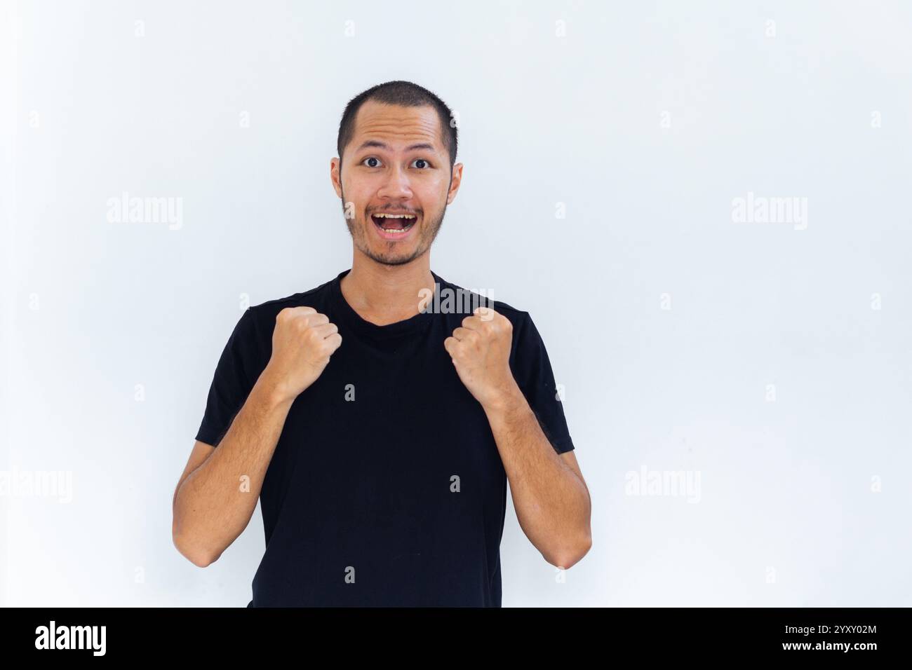 Young men is posing winning gesture with palm fist hand with black ...
