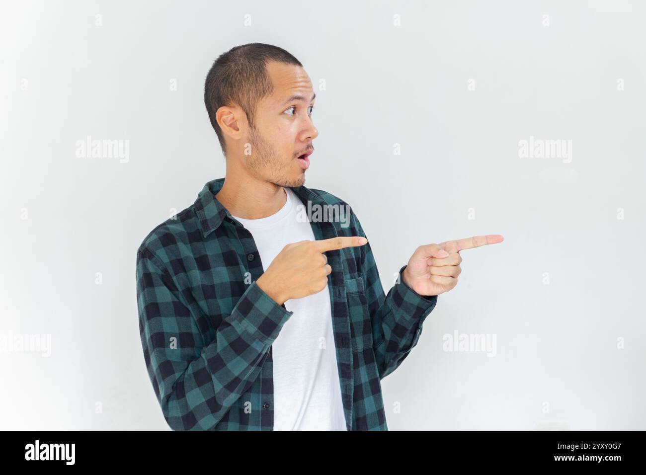 Young Adult Asian men wearing flannel and shirt pointing finger to the ...