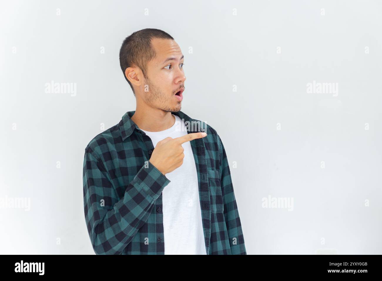 Young Adult Asian men wearing flannel and shirt pointing finger to the ...