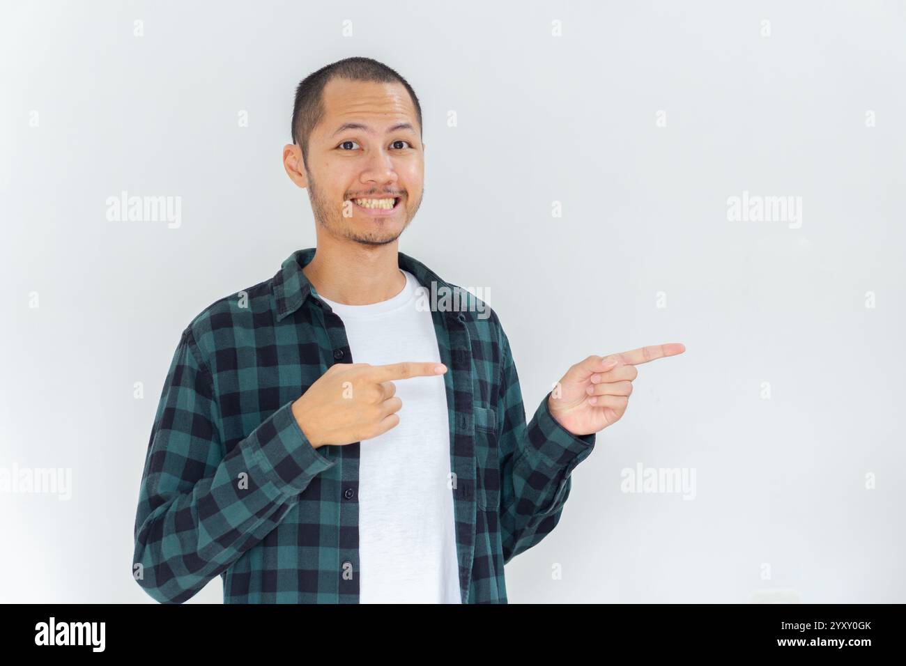 Young Adult Asian men wearing flannel and shirt pointing finger to the ...