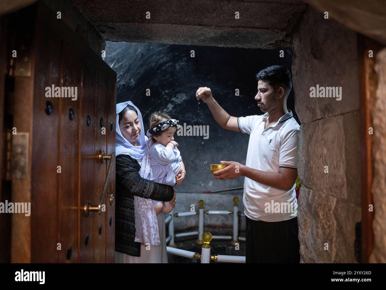A child is baptized in Lalish, the Yazidi's most holy temple, in the ...