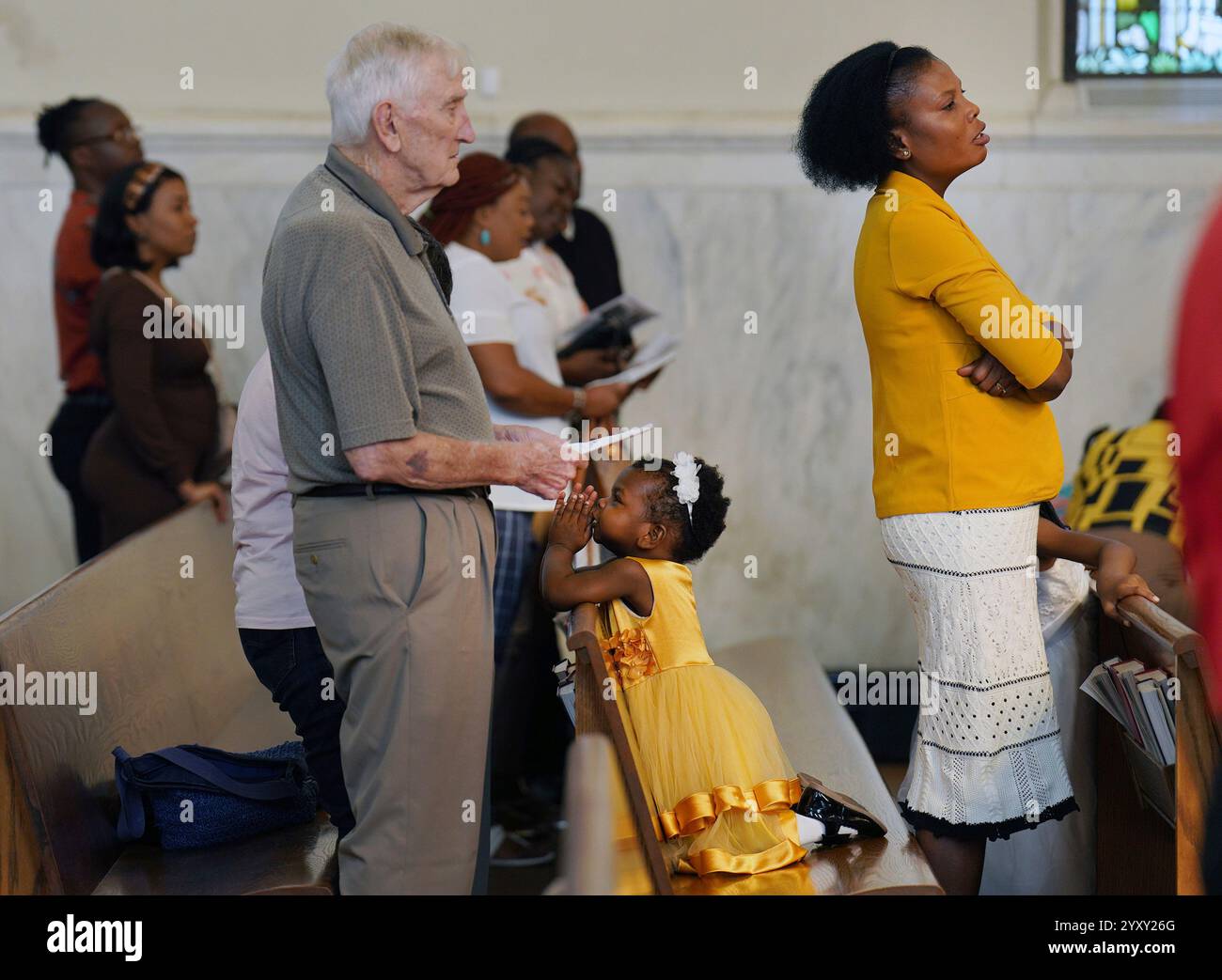 Phara Pierre, right, and her daughter attend Mass at St Raphael ...