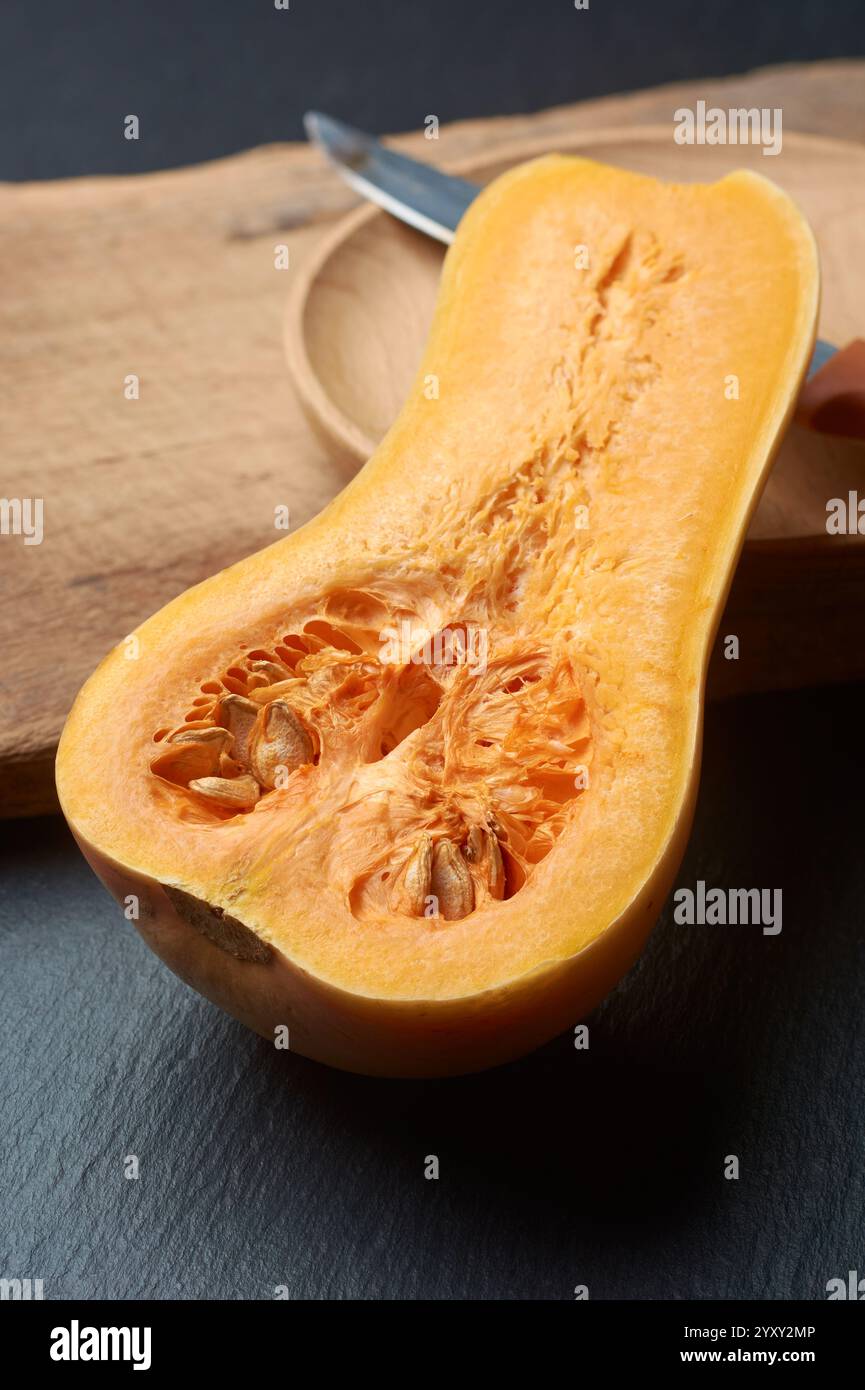 butternut squash cut in half revealing vibrant orange flesh and seeds ...