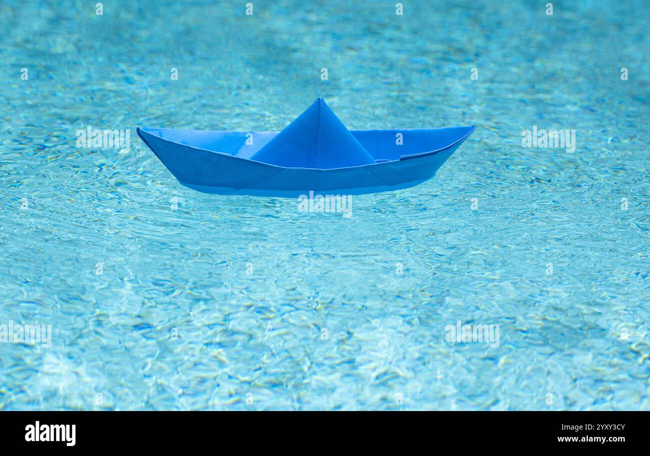 Paper ship and ocean water. Summertime vacation. Tourism and traveling ...