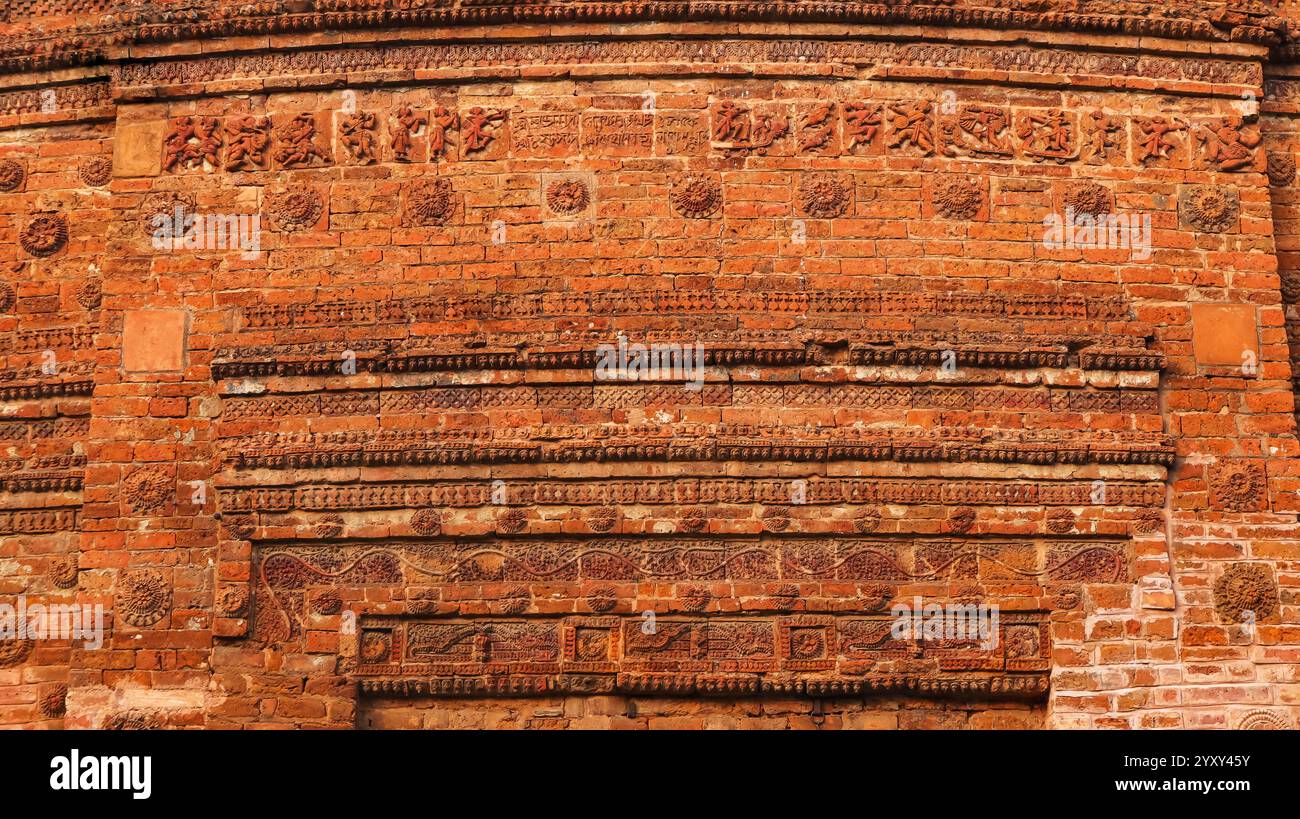 Intricate terracotta carvings and inscriptions adorning the walls of ...