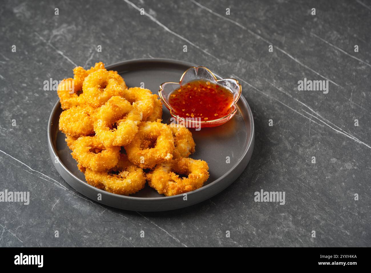 Deep fried squid rings breaded with thai sauce Stock Photo - Alamy