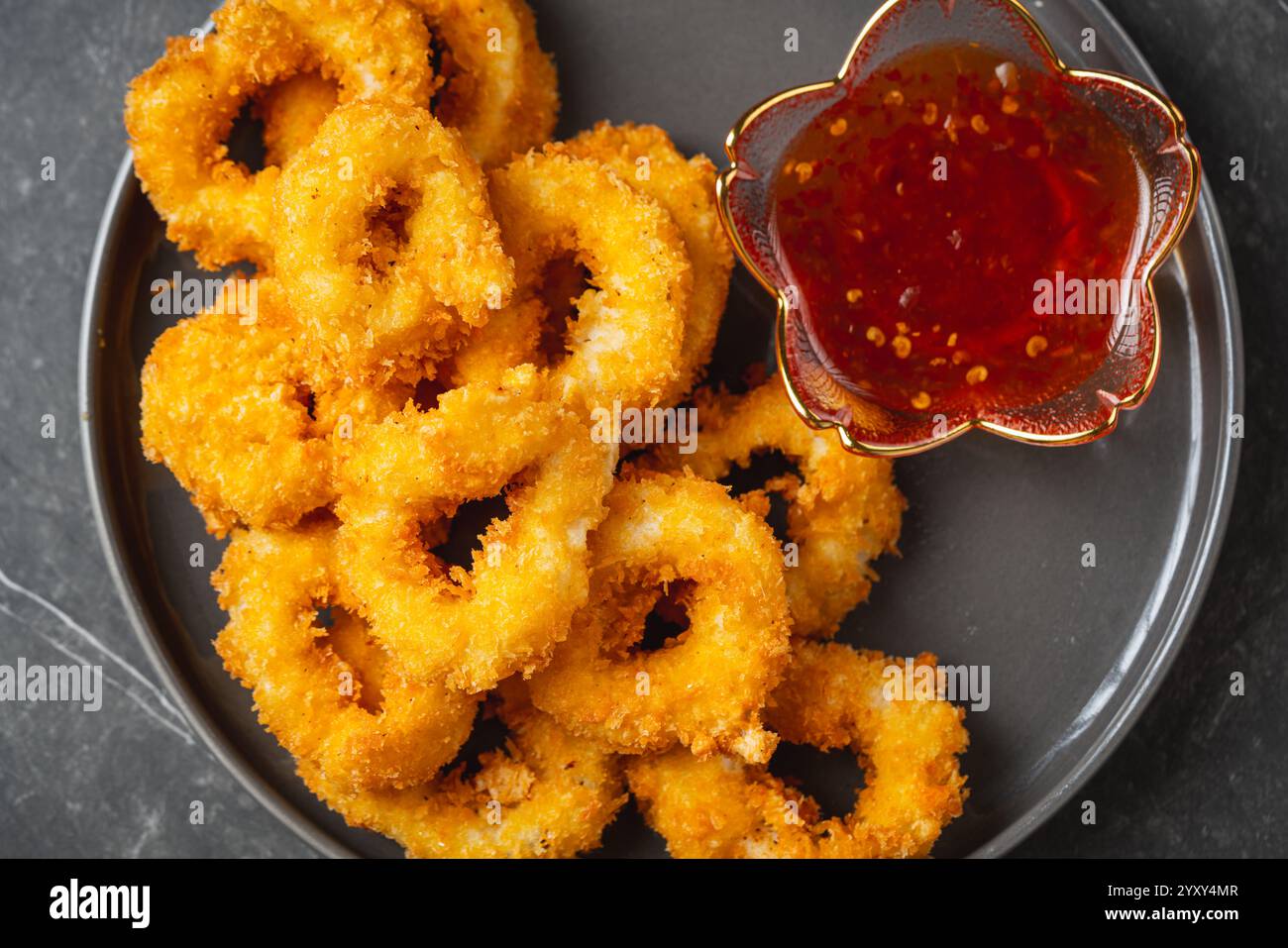 Deep fried squid rings breaded with thai sauce Stock Photo - Alamy