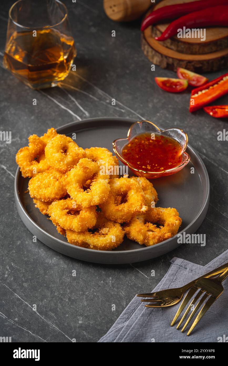 Deep fried squid rings breaded with thai sauce Stock Photo - Alamy