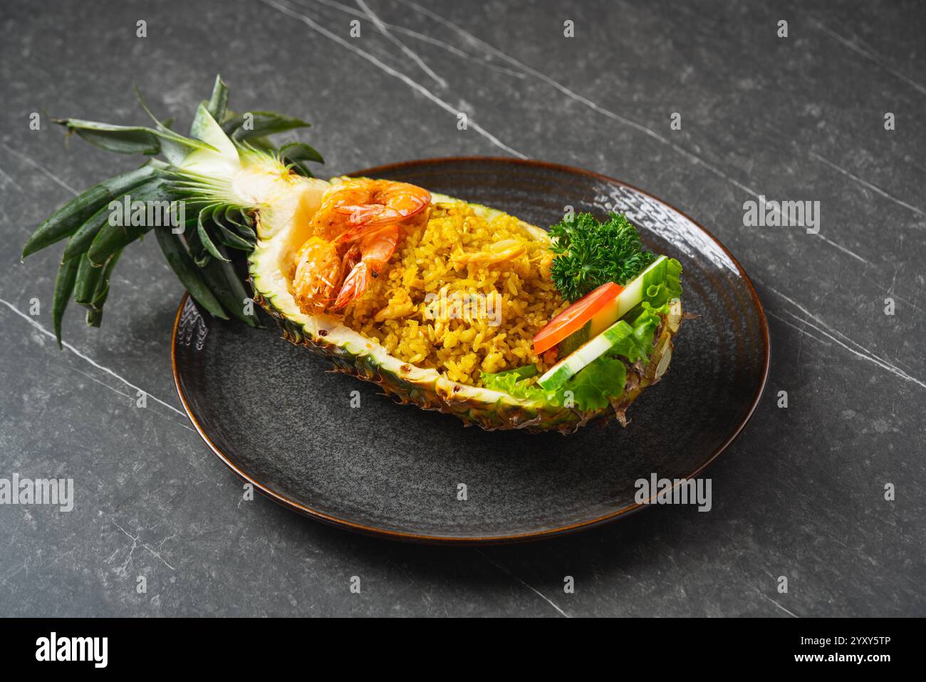 Pineapple fried rice with seafood served in a pineapple Stock Photo - Alamy