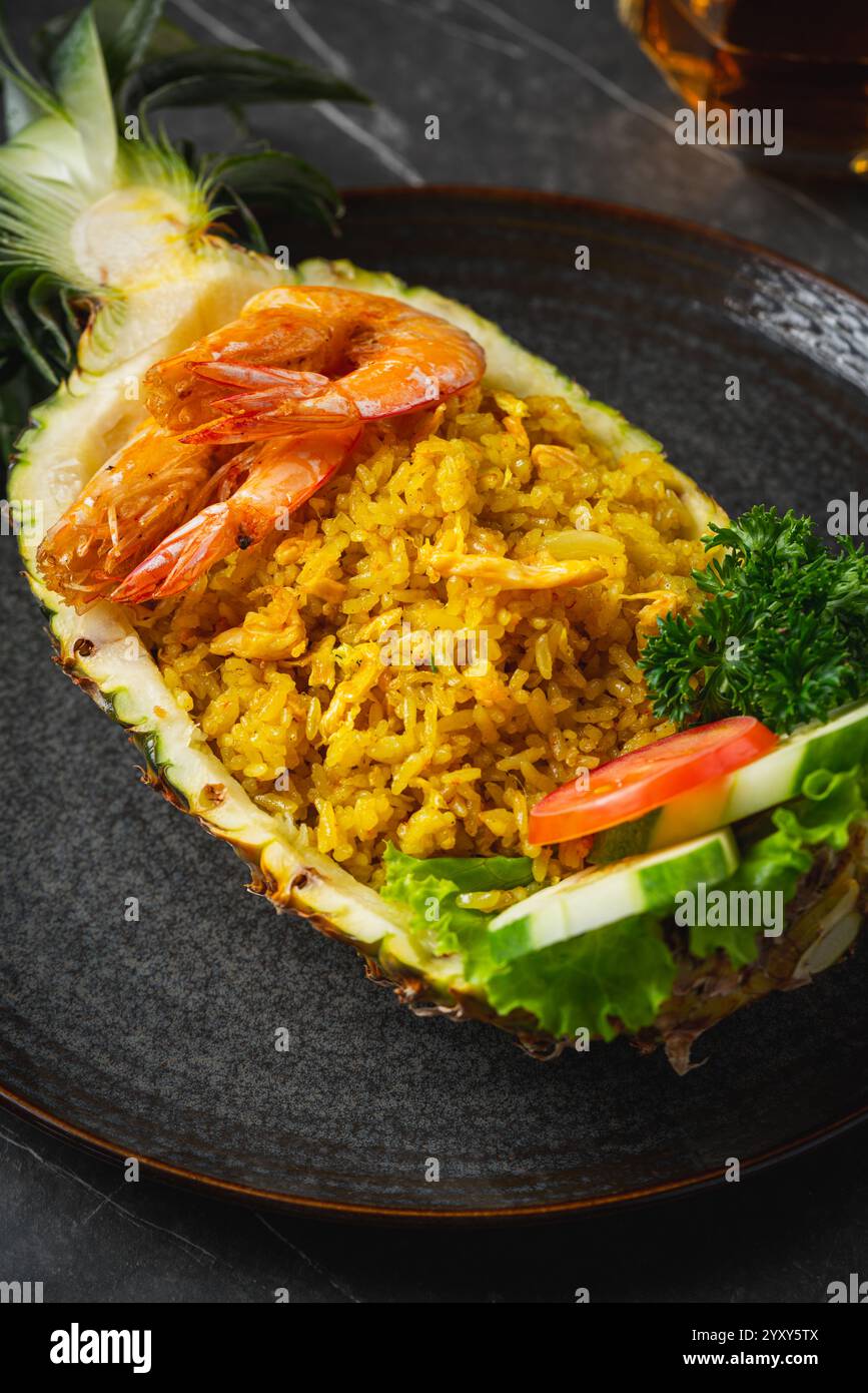 Pineapple fried rice with seafood served in a pineapple Stock Photo - Alamy