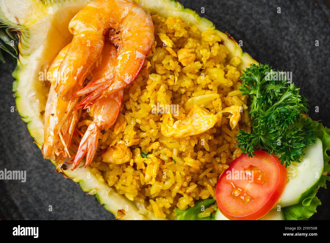 Pineapple fried rice with seafood served in a pineapple Stock Photo - Alamy