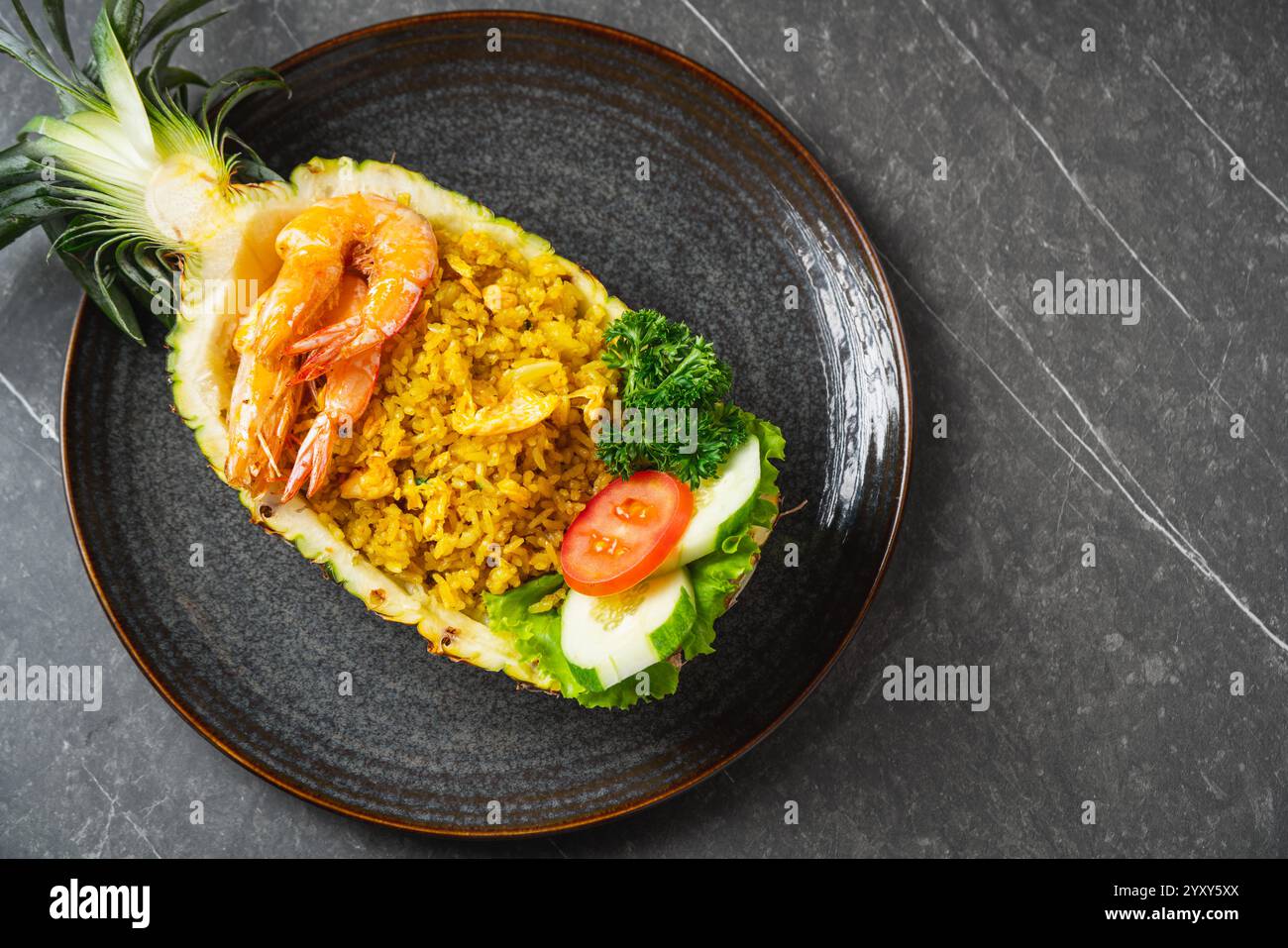 Pineapple fried rice with seafood served in a pineapple Stock Photo - Alamy