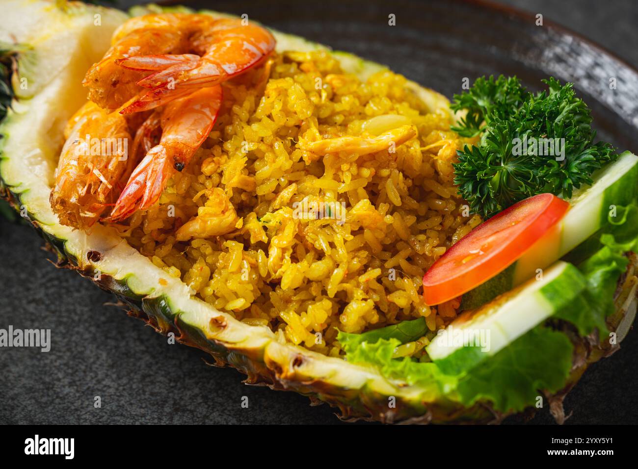 Pineapple fried rice with seafood served in a pineapple Stock Photo - Alamy