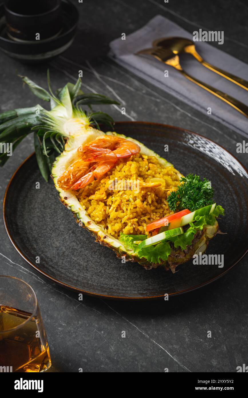 Pineapple fried rice with seafood served in a pineapple Stock Photo - Alamy