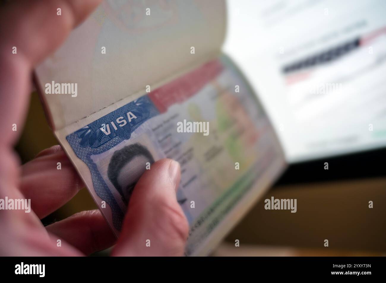 Unknown causian person holding passport with visa issued for United ...