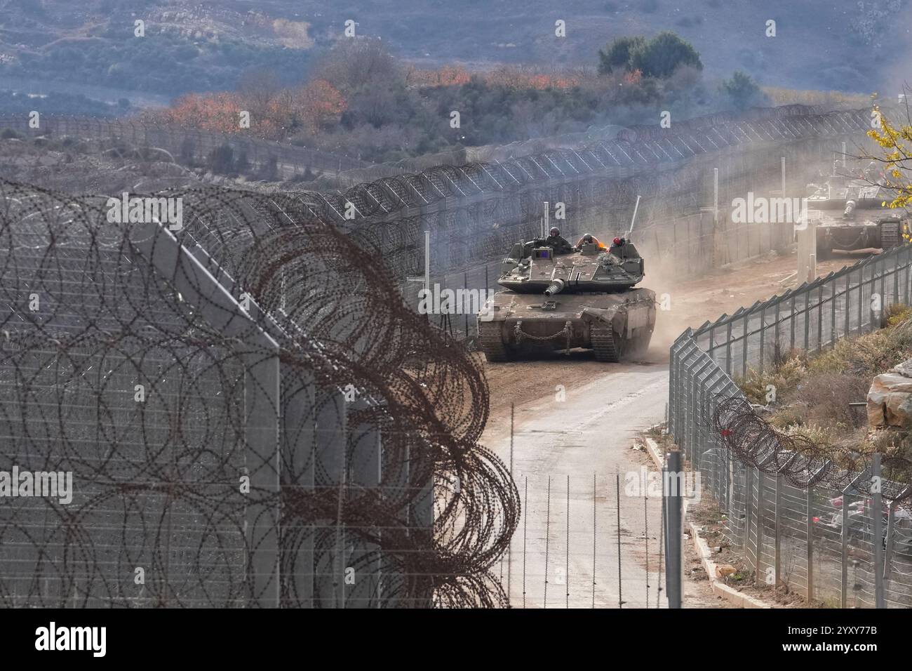 An Israeli army tank maneuvers near the "Alpha Line" that separates the ...