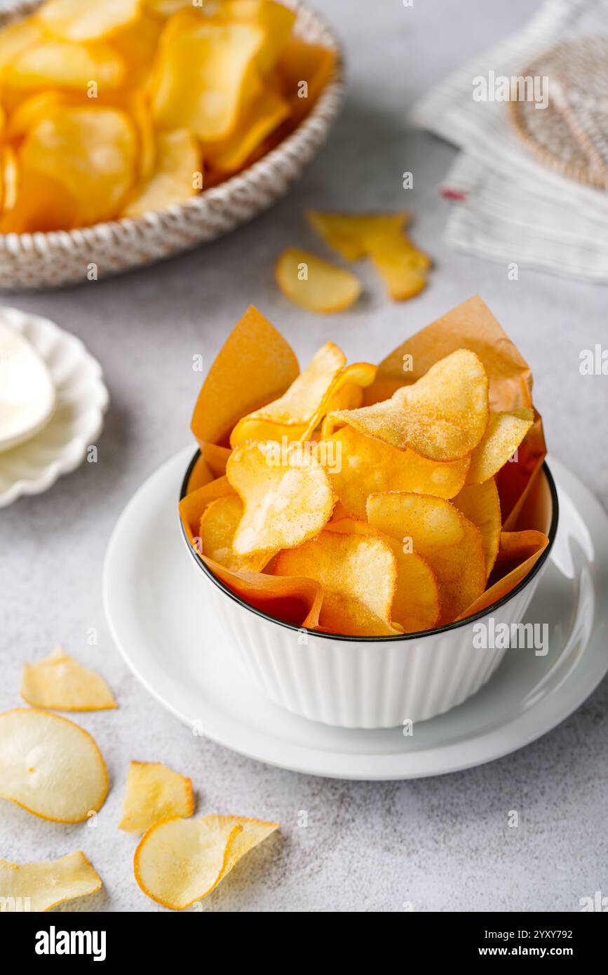 Cassava chips, a traditional Indonesian snack, are made from thin ...