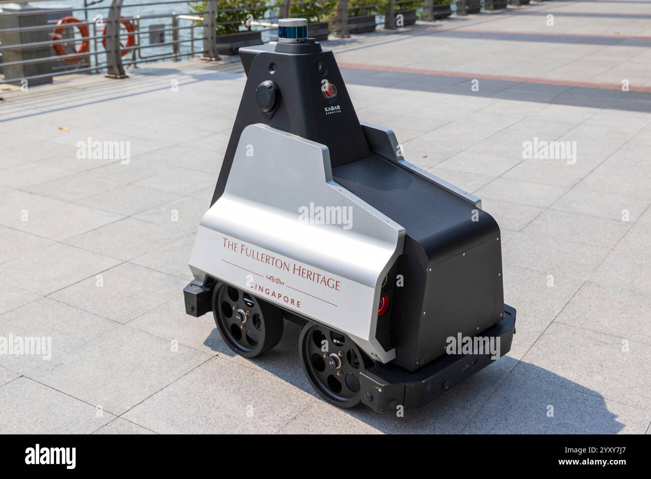 The Fullerton Hotel automatic street cleaner moves along the pavement ...