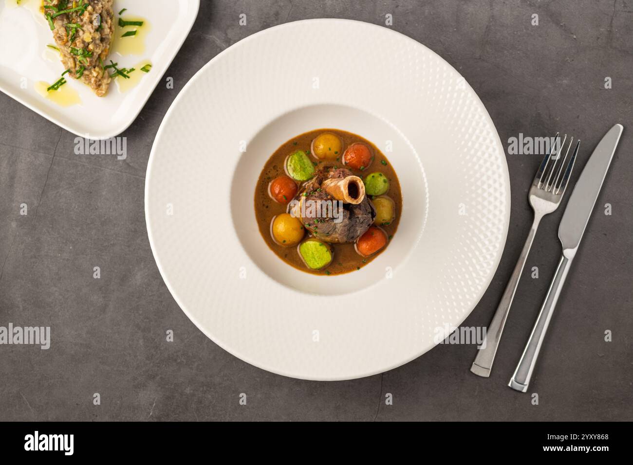 Traditional slow-cooked braised lamb knuckle or lamb shank with sauces ...