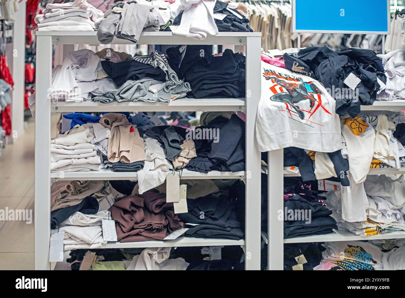 stylish clothes on the shelves in the supermarket after customers try ...