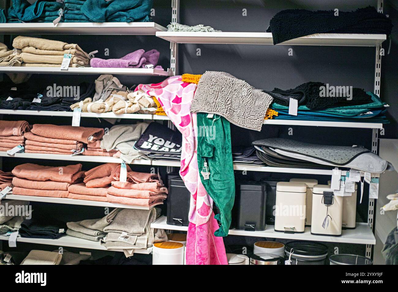 stylish clothes on the shelves in the supermarket after customers try ...