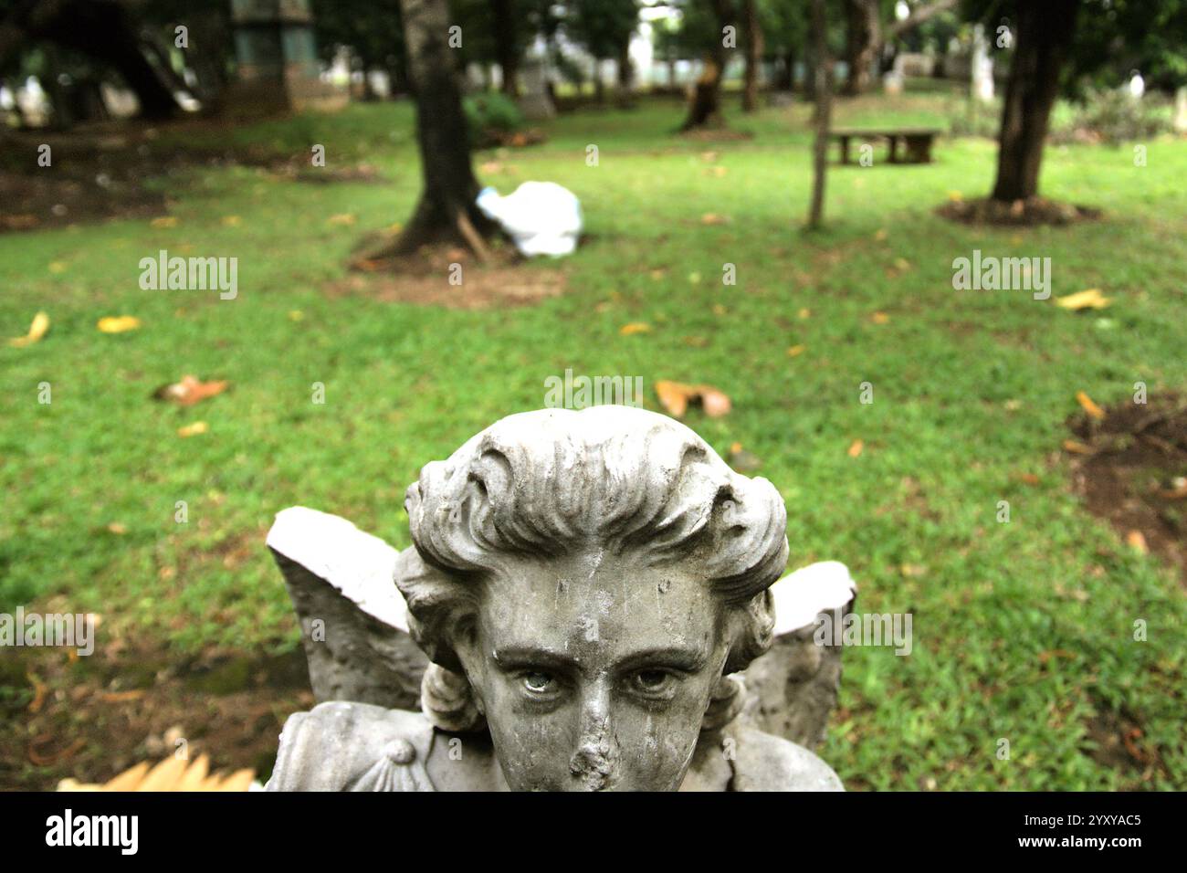 A broken statue of an angel figure at Taman Prasati museum (museum of ...