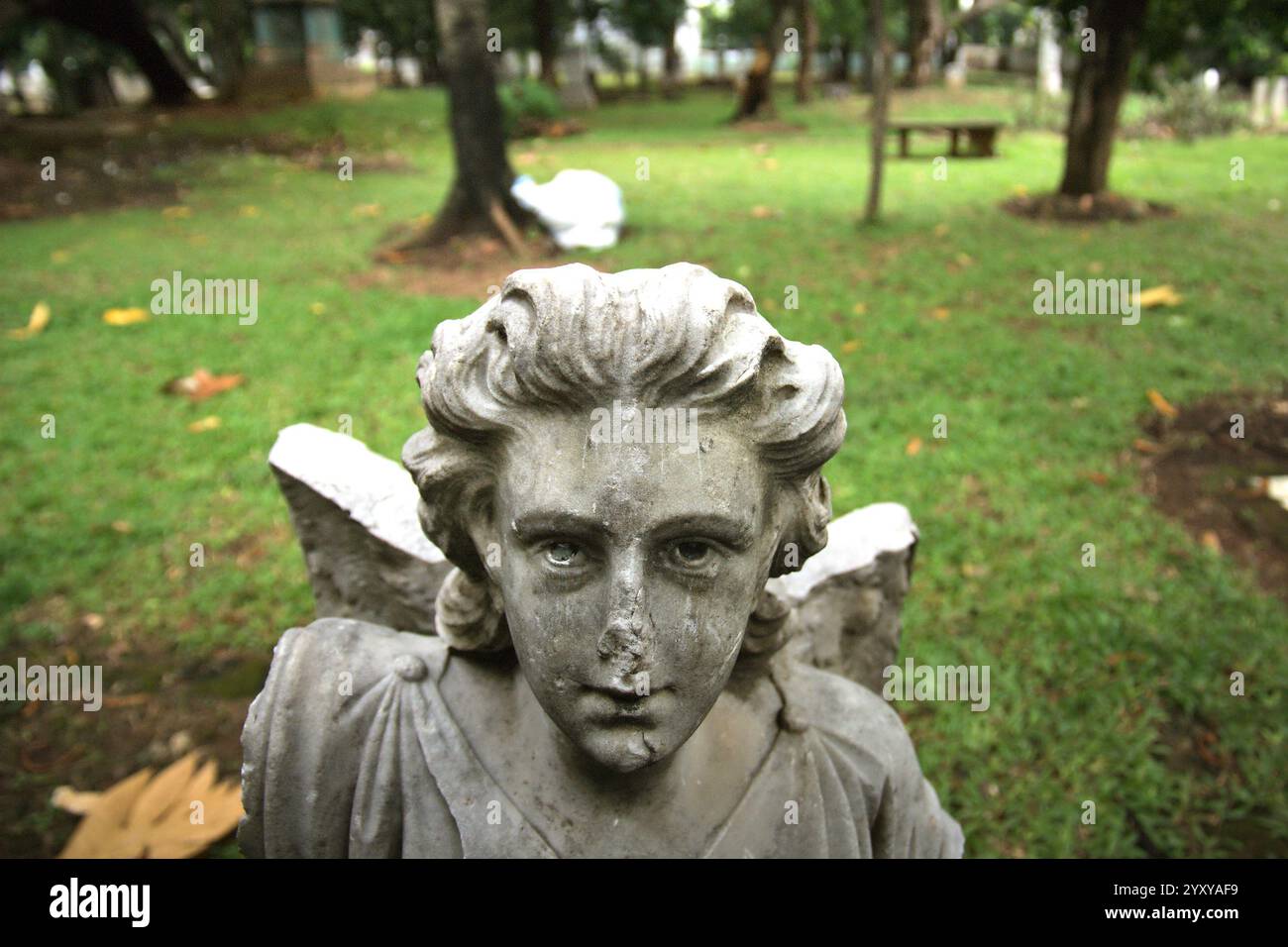 A broken statue of an angel figure at Taman Prasati museum (museum of ...