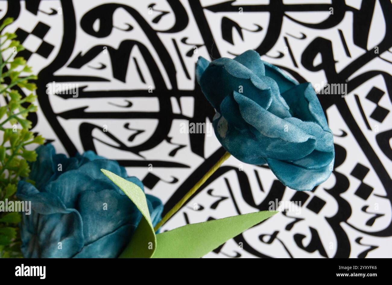 A blue rose placed on a blurred background of Arabic text Stock Photo ...