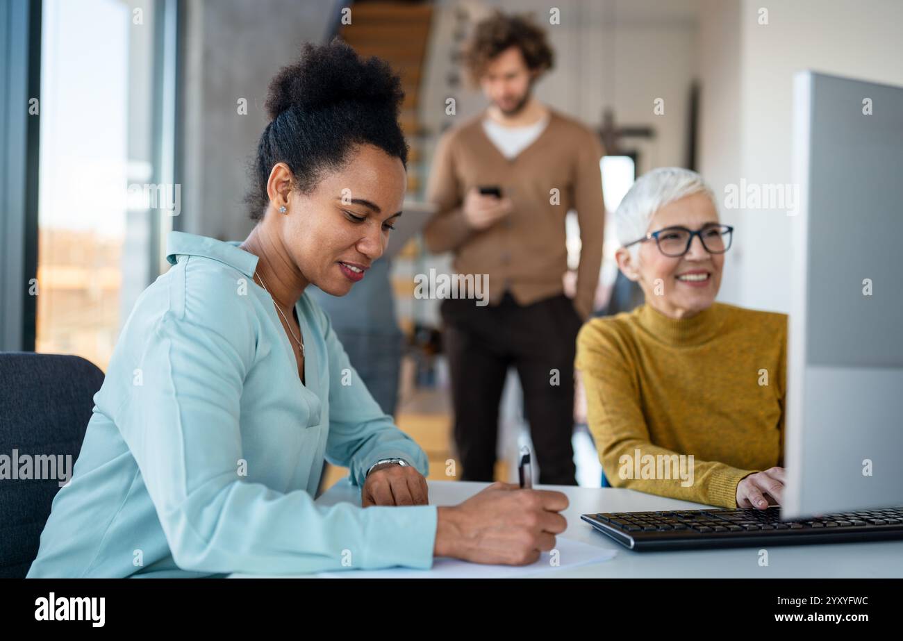 Multiracial coworkers analyzing charts and working together showing ...