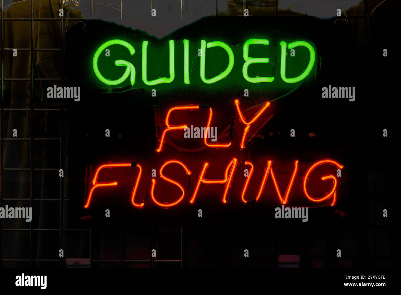 Neon sign in shop window advertising guided fly fishing in Red River ...