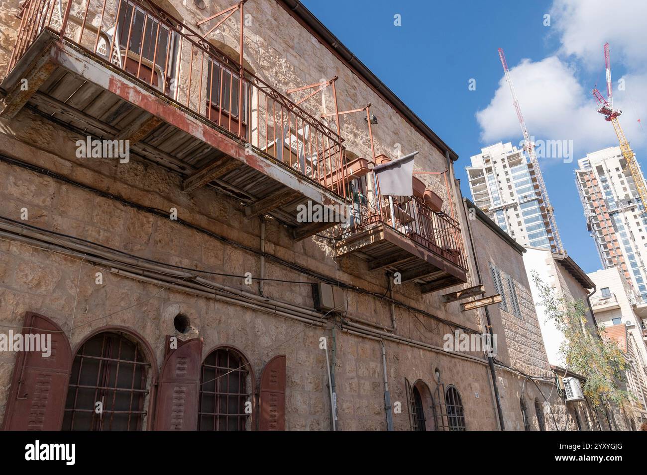 New construction seen next to old buildings on street in Jerusalem ...