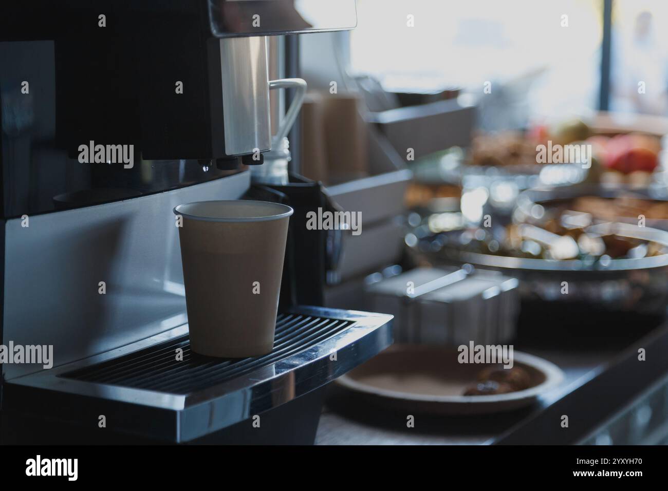 Coffee machine prepares coffee in a cup for takeaway, at a buffet Stock ...