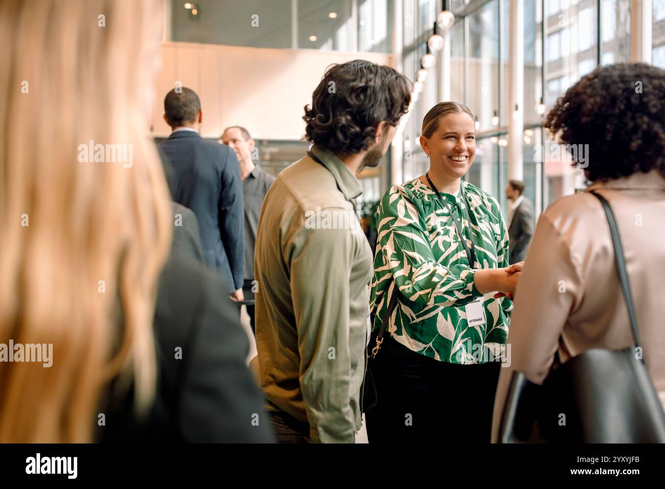 Group of male and female business delegates interacting with each other ...