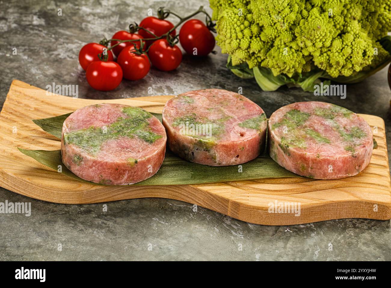 Raw Tuna medallion with broccoli cabbage Stock Photo - Alamy