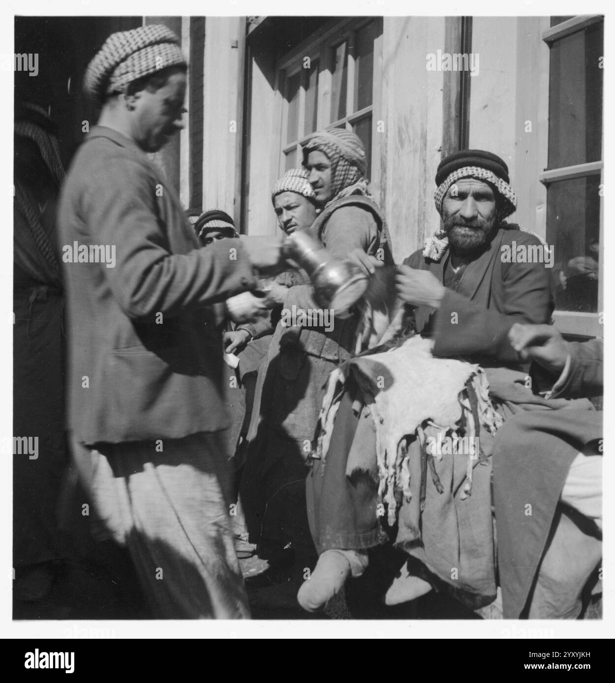 Iraq, Bagdhad (Baghdad): Street scene; tea serving on the street, group ...