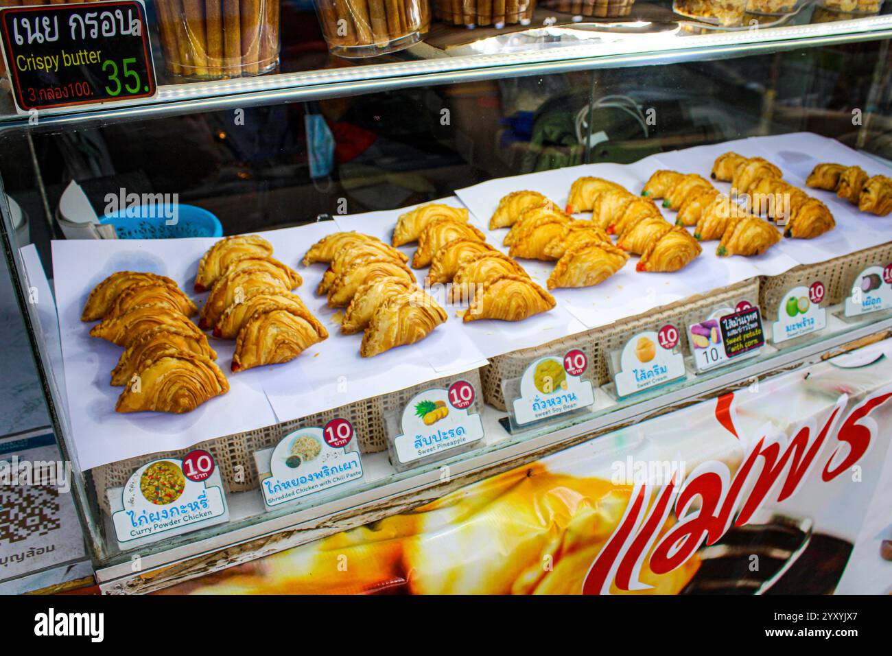 Sweet and savoury stuffed pastries for sale at a street food stall in ...