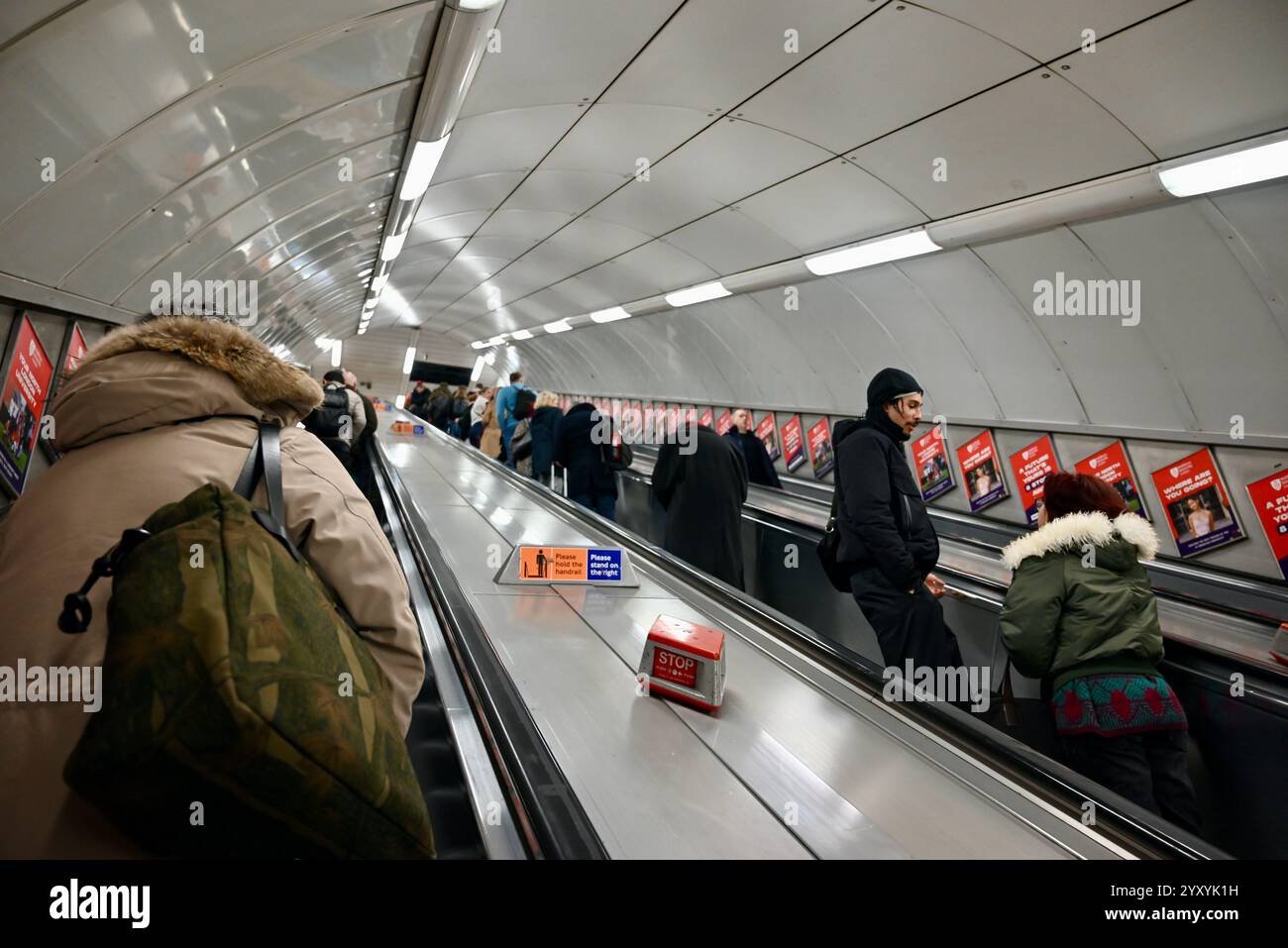 passengers on an escalator at kings cross tube station london england ...
