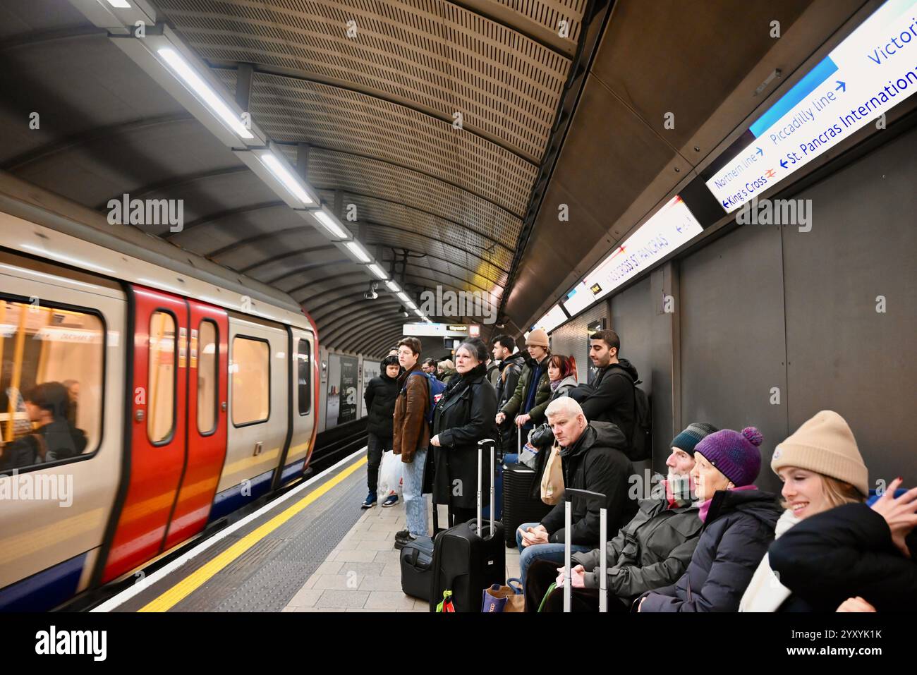 customers travellers and passengers wait on kings cross underground ...