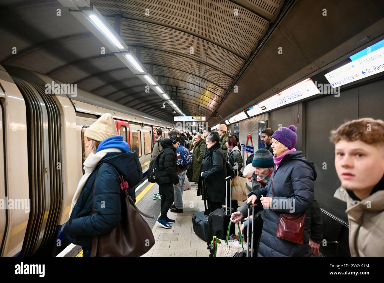 customers travellers and passengers wait on kings cross underground ...