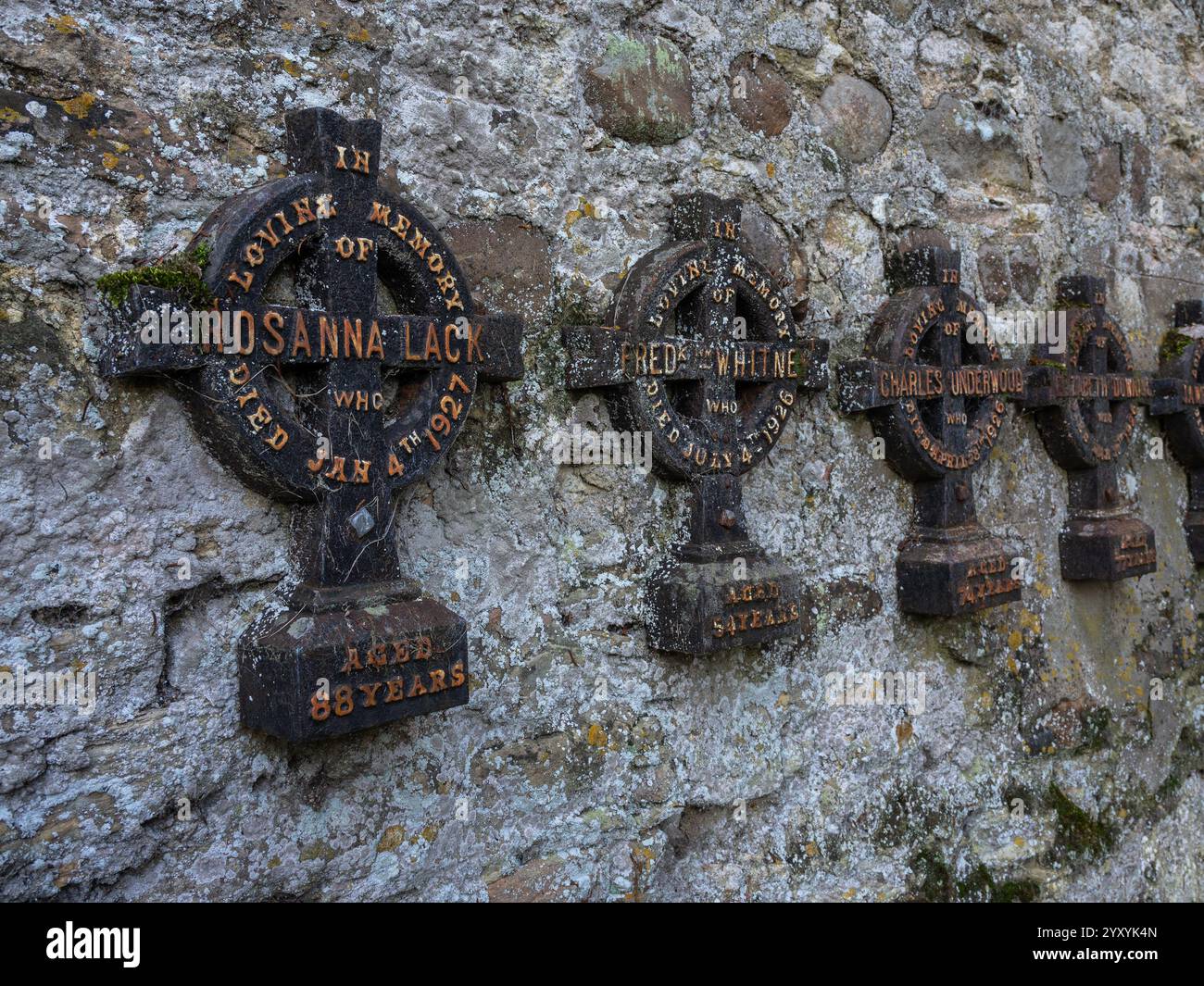 Wall mounted cast iron memorial plaques on the exterior of the church ...