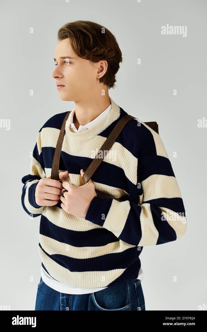 This handsome young man exudes confidence in a striped sweater, ready ...