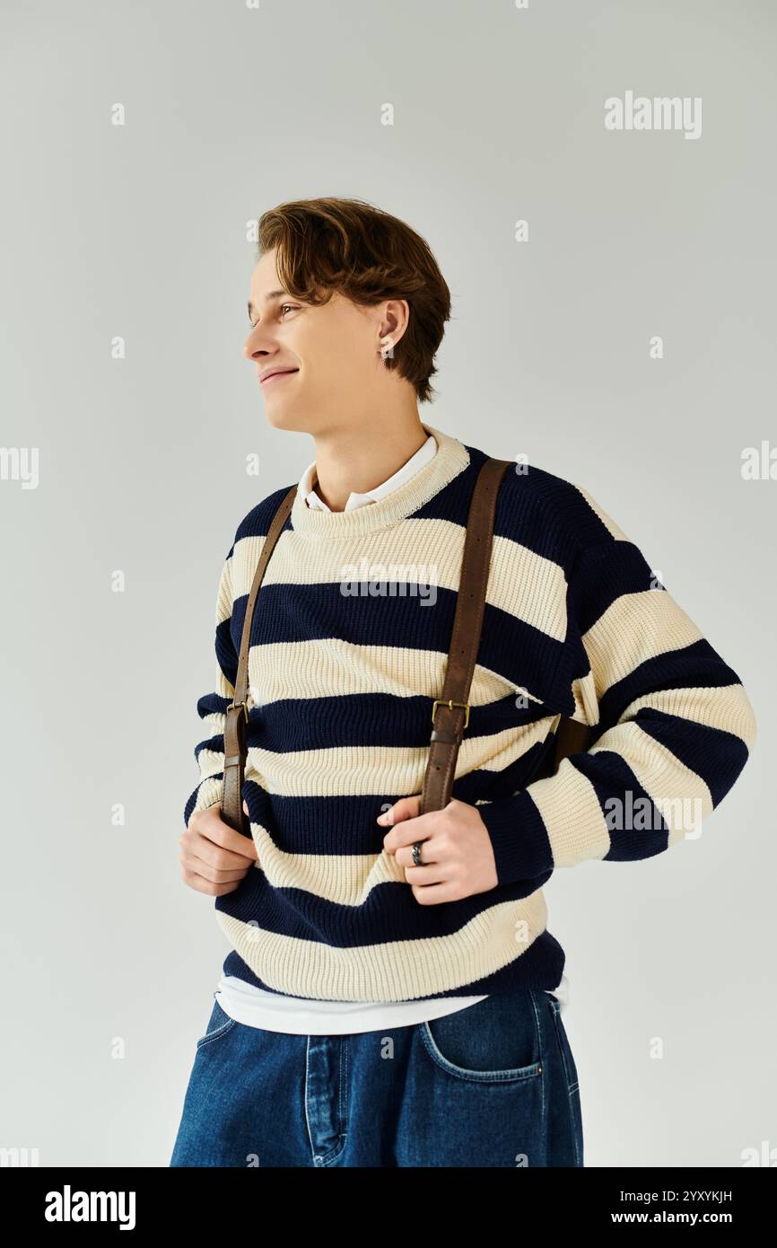 A handsome young man showcases his style in a striped sweater ...