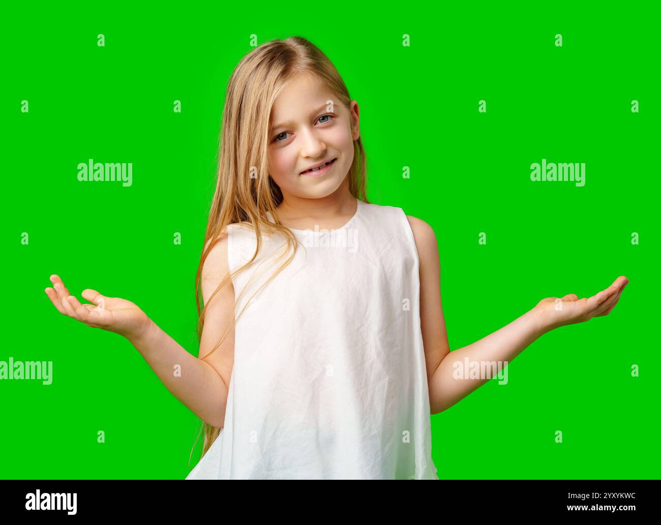 A young girl with long hair in a white dress poses with open arms ...