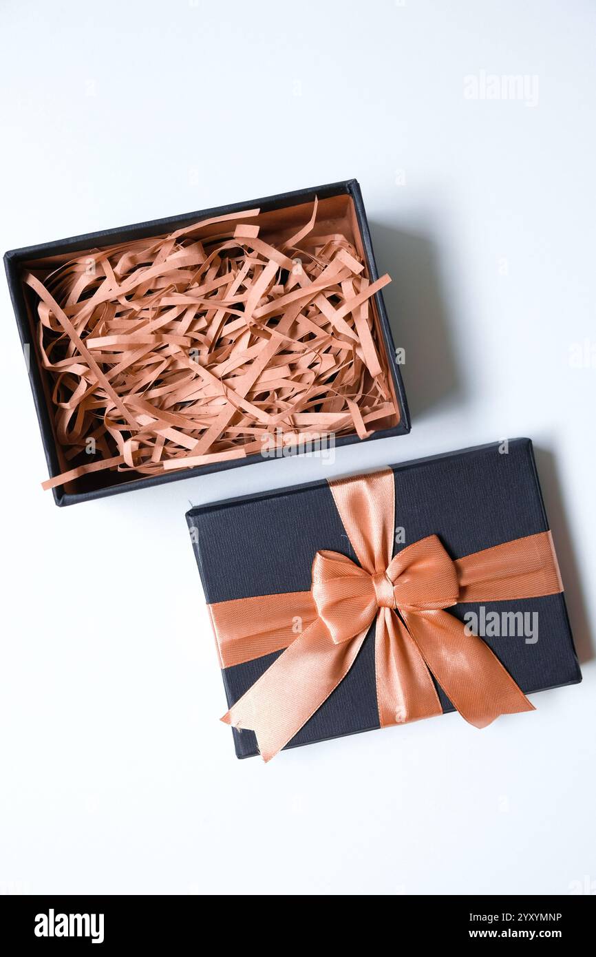 Open gift box with shredded paper Stock Photo - Alamy
